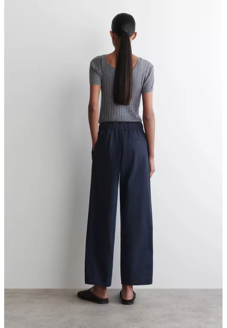 Buy COS COTTON TAPERED DRAWSTRING TROUSERS 2026 Online | ZALORA