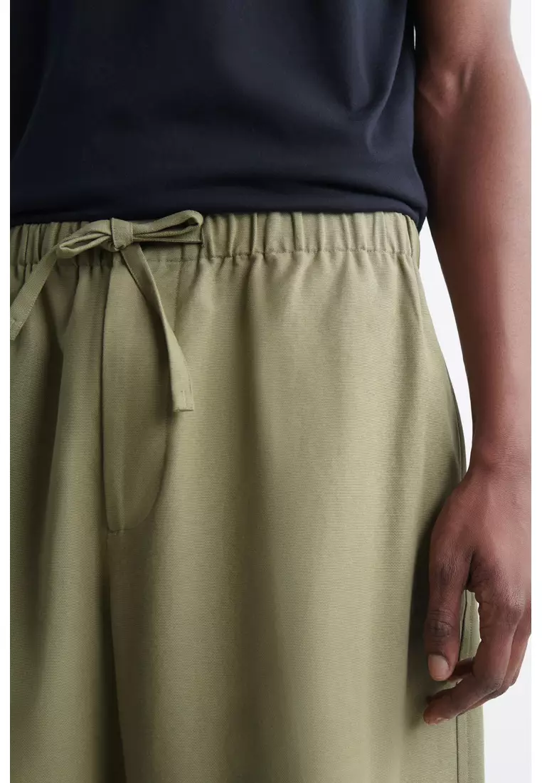 Buy COS RELAXED-FIT BARREL-LEG DRAWSTRING TROUSERS 2026 Online | ZALORA