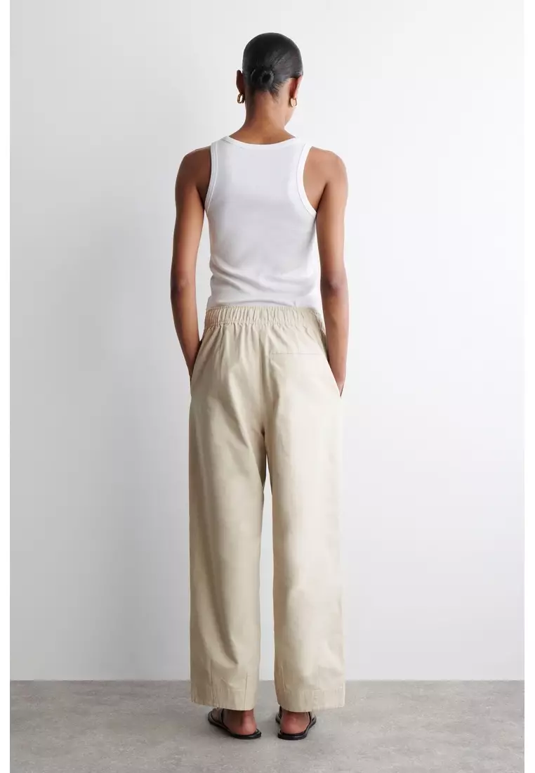 Buy COS COTTON TAPERED DRAWSTRING TROUSERS 2026 Online | ZALORA