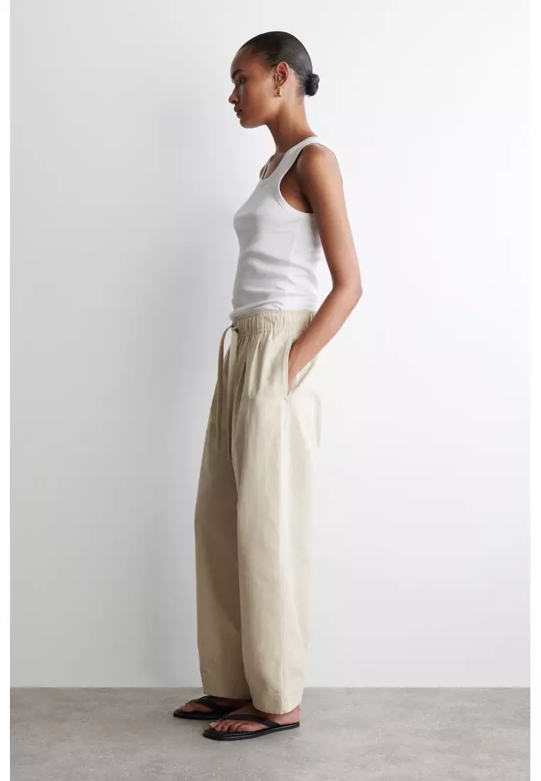 Buy COS COTTON TAPERED DRAWSTRING TROUSERS 2026 Online | ZALORA